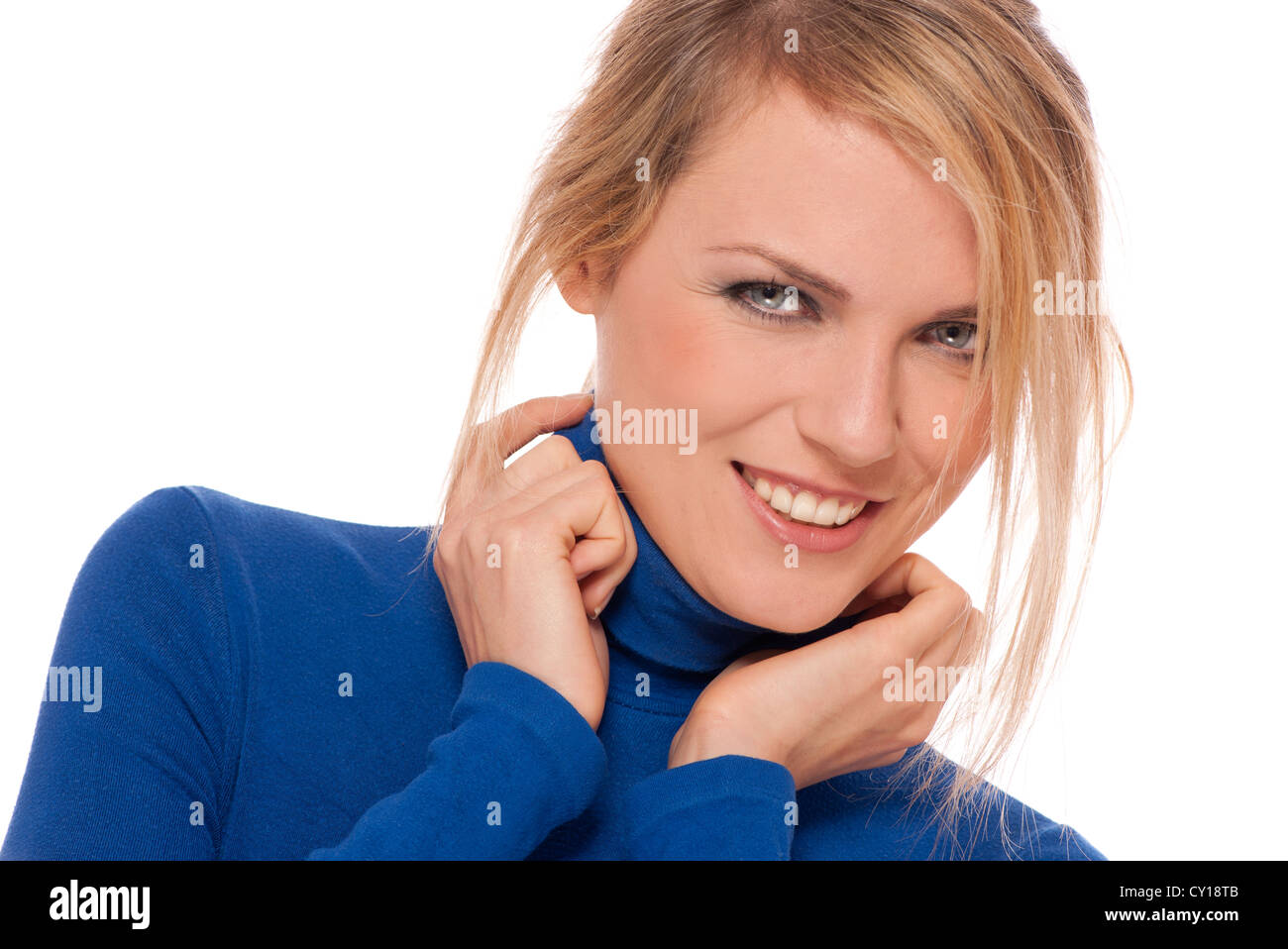 woman smiling wearing blue polo neck jumper Stock Photo - Alamy