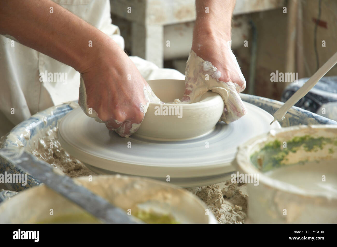 Potter throwing a plate on a wheel, UK Stock Photo - Alamy