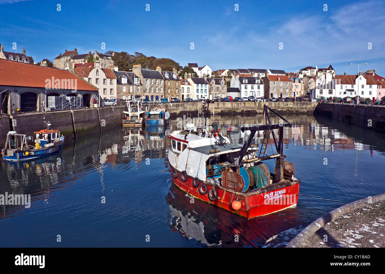 Fishing boat has just arrived in Pittenweem harbour Fife Scotland to ...