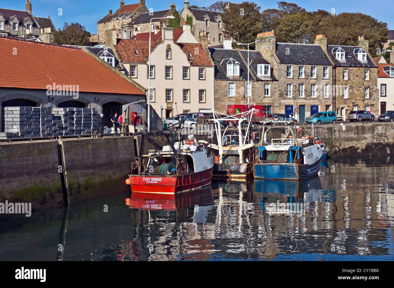 Fishing boat has just arrived in Pittenweem harbour Fife Scotland and ...