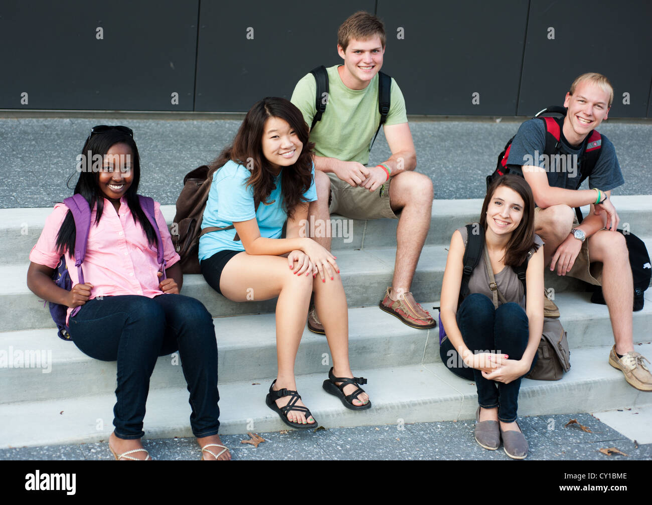 Diverse group of friends outside smiling together Stock Photo - Alamy