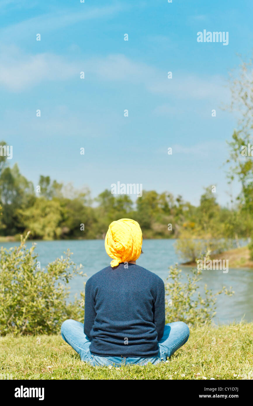 Rear view of woman sitting in meadow, France Stock Photo - Alamy