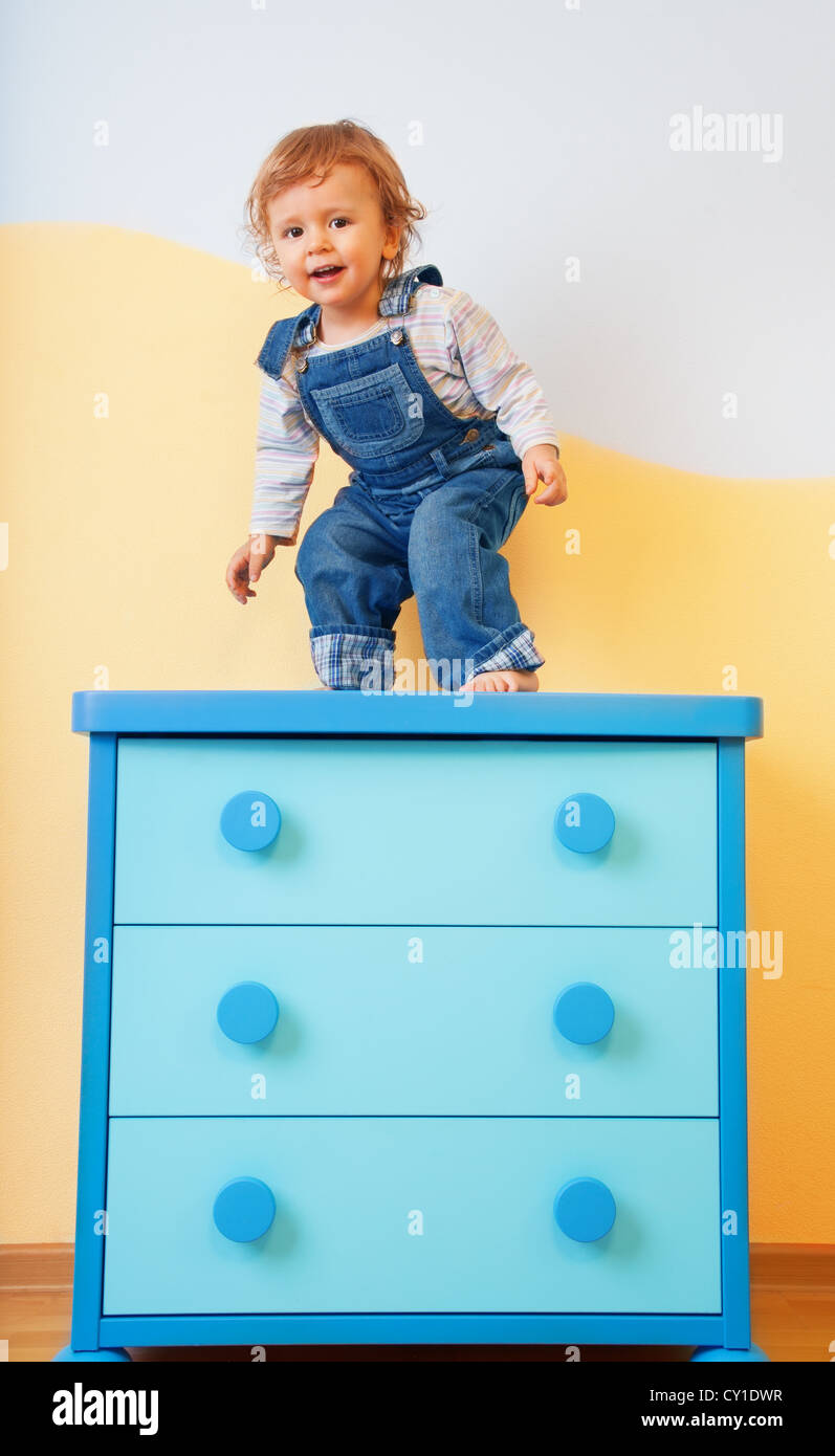 Toddler standing and jumping from furniture Stock Photo - Alamy