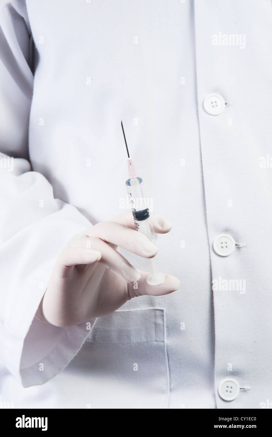 Doctor / Nurse holding a syringe ready an injection Stock Photo - Alamy