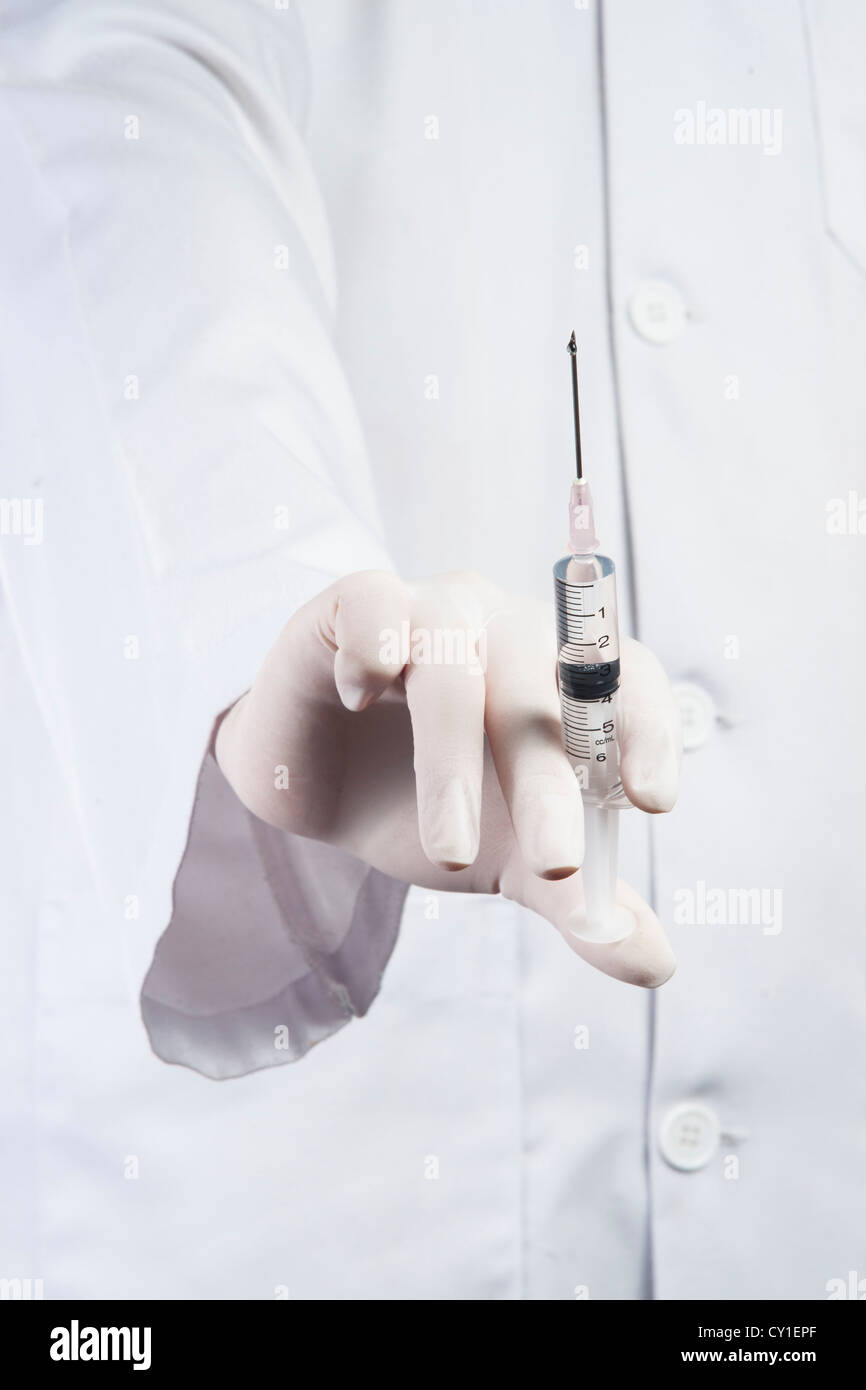 Doctor / Nurse holding a syringe ready an injection Stock Photo - Alamy