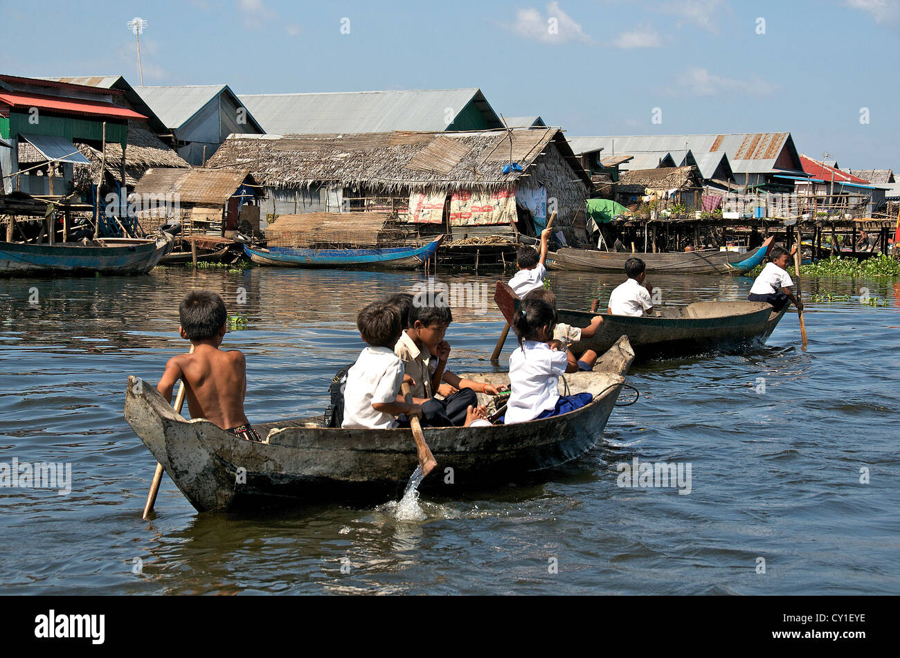 schoolchildren boat boating row rowing water Tonle Sap lake Camnbodia ...