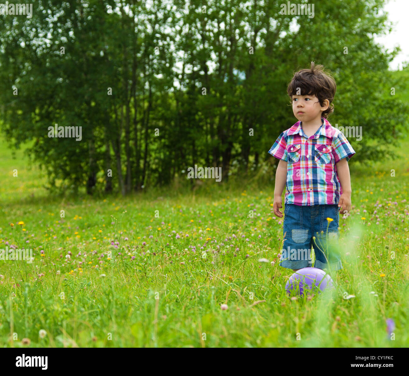 sad boy waiting friend in the park to play football Stock Photo - Alamy