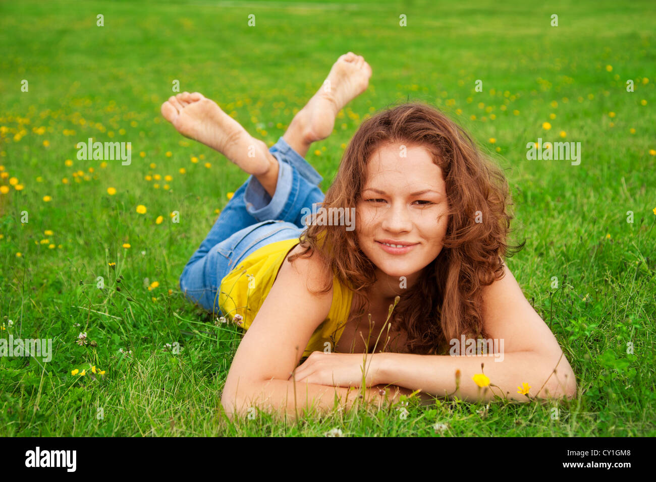 pretty girl laying on soft green grass Stock Photo - Alamy