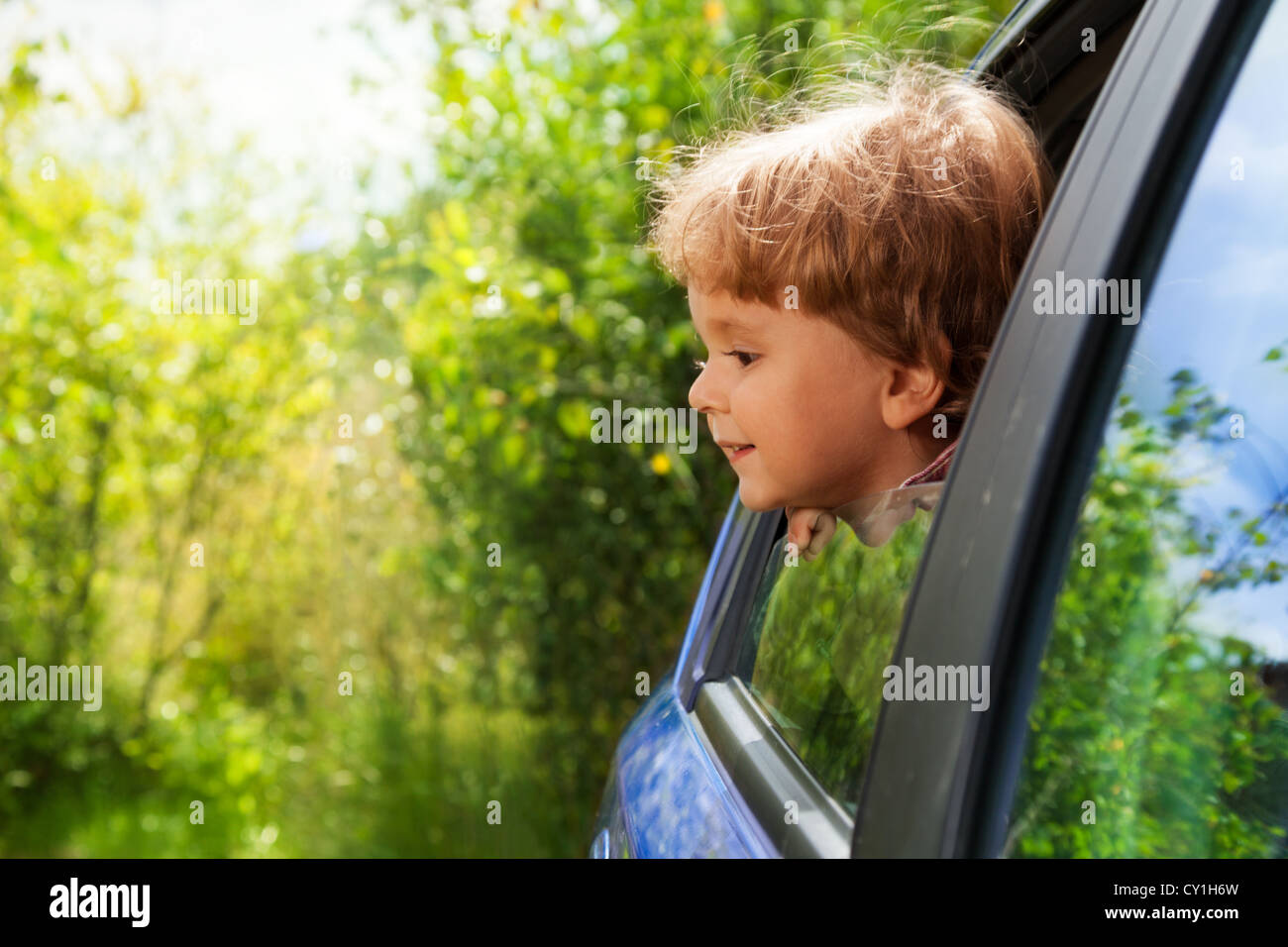 curious funny little kid looking outside of car window Stock Photo - Alamy