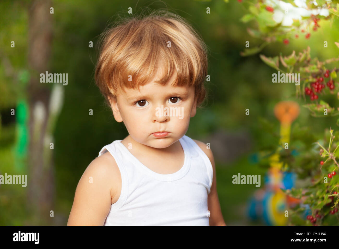 moody boy's portrait in the garden Stock Photo - Alamy