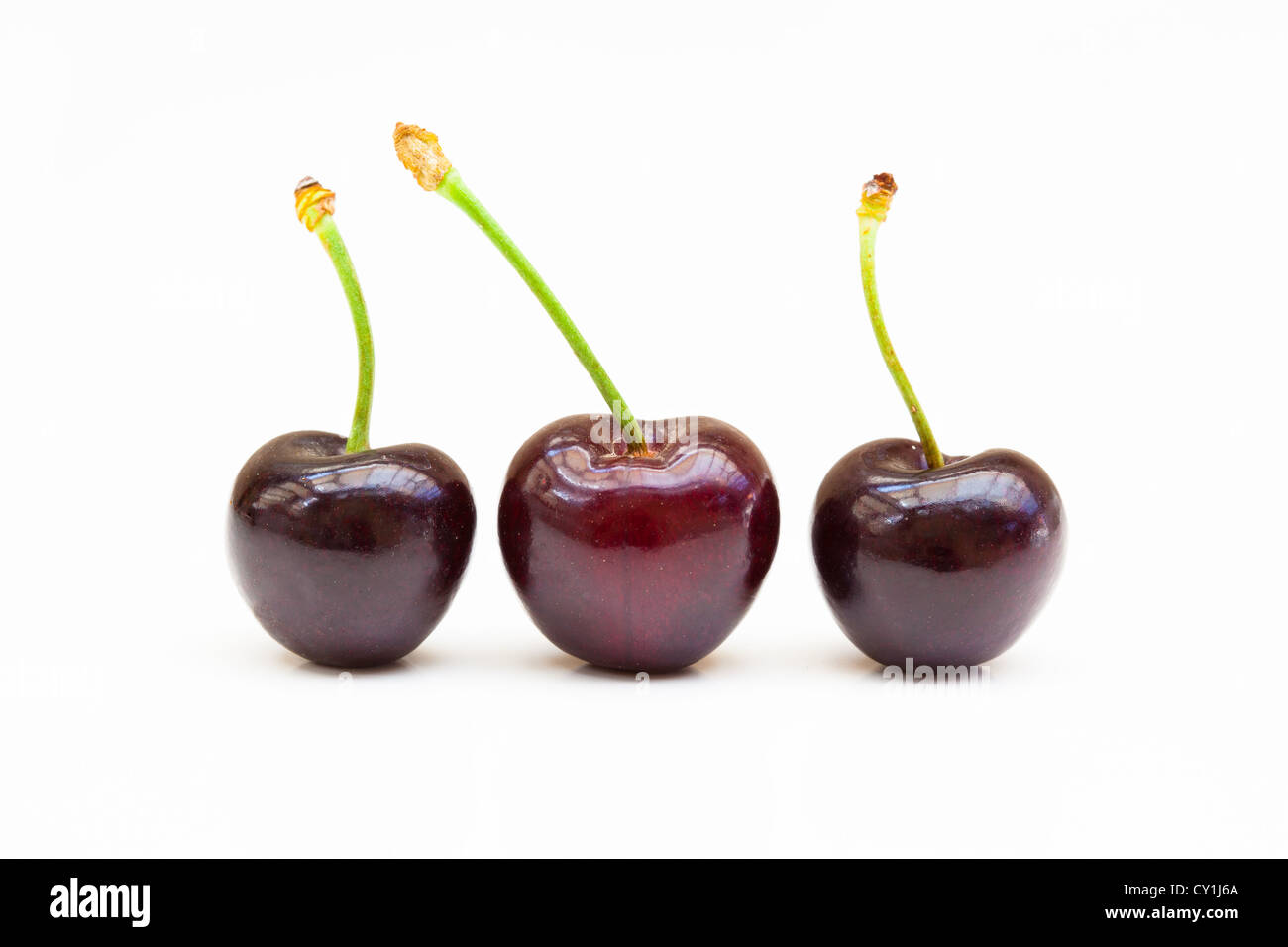 Three cherries in a row Stock Photo - Alamy