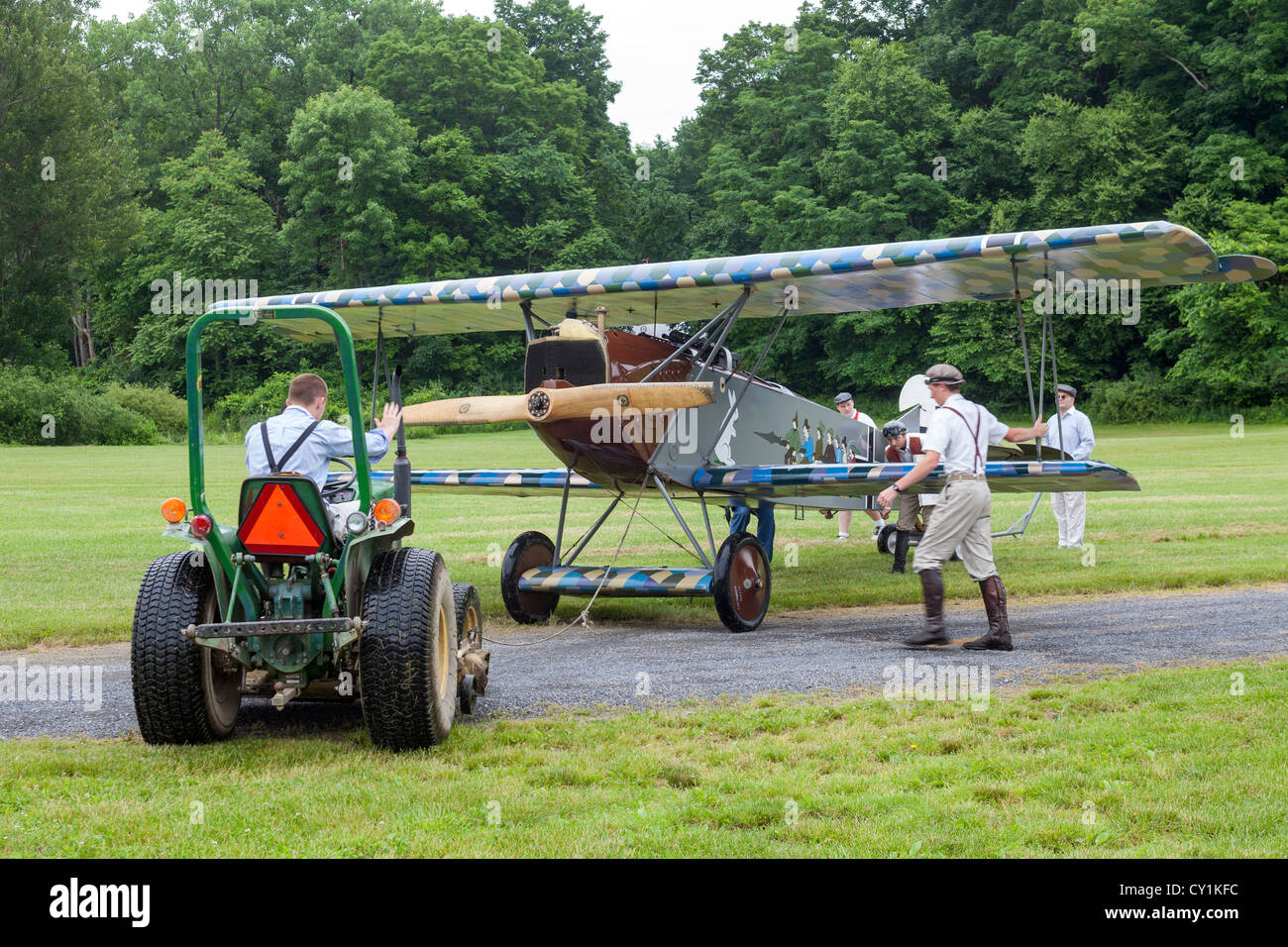 A group of men move an antique biplane from an airfield Stock Photo - Alamy