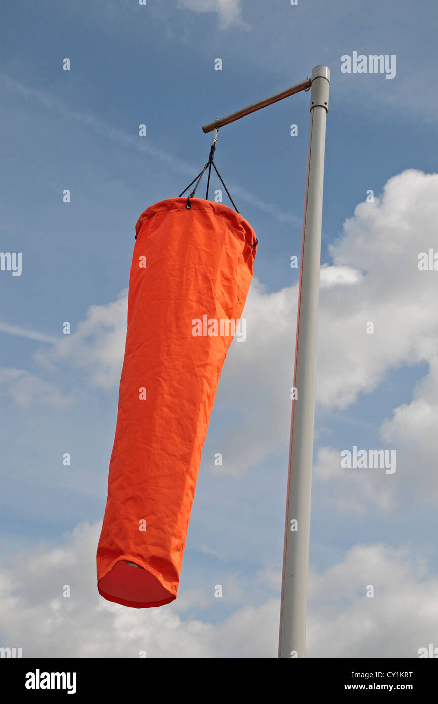 An orange coloured windsock against a blue background, UK Stock Photo ...