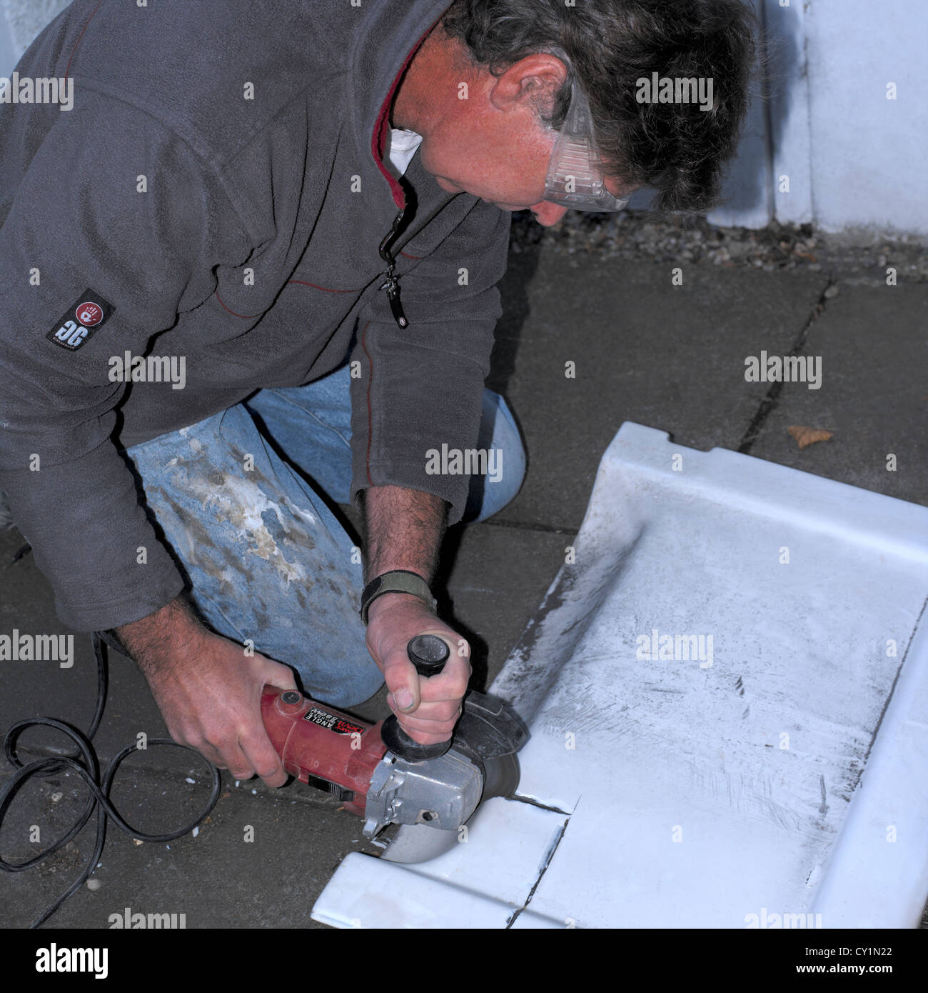 Cutting Ceramic with Hand Held Blade in New Bathroom Stock Photo - Alamy