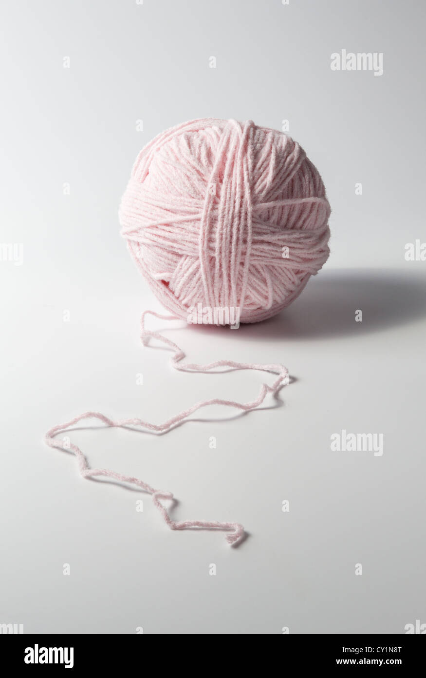a ball of pink yarn on gray background Stock Photo - Alamy
