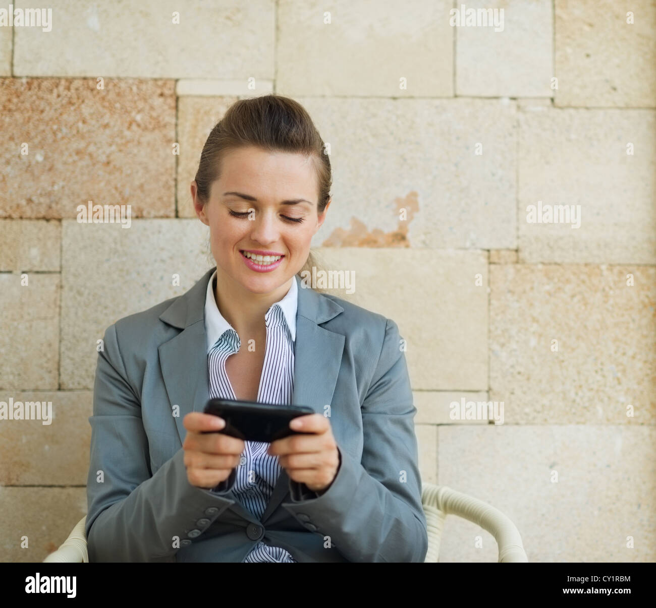 Happy business woman writing text message on cell pone Stock Photo - Alamy