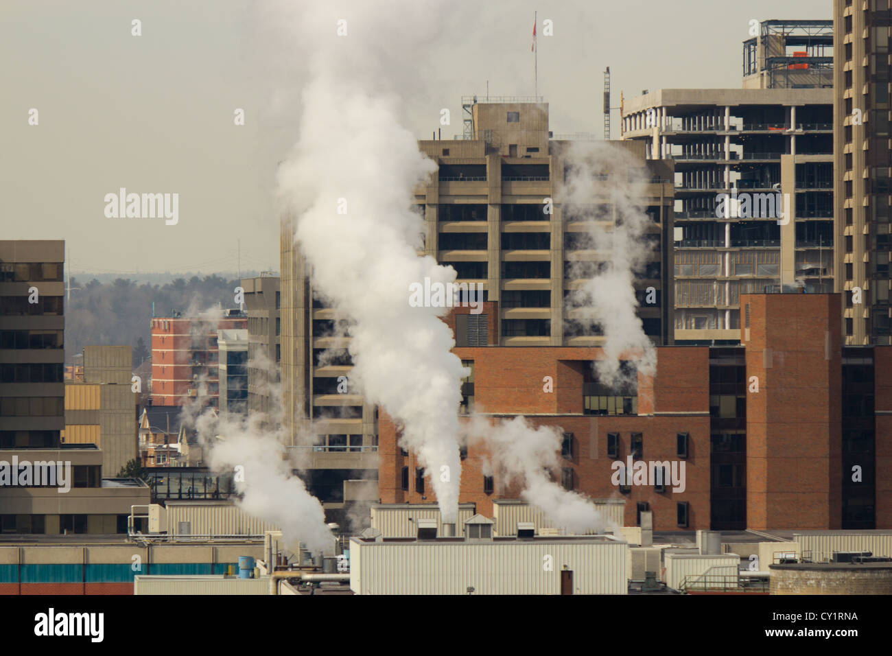 Industry pollution over a downtown city core Stock Photo - Alamy