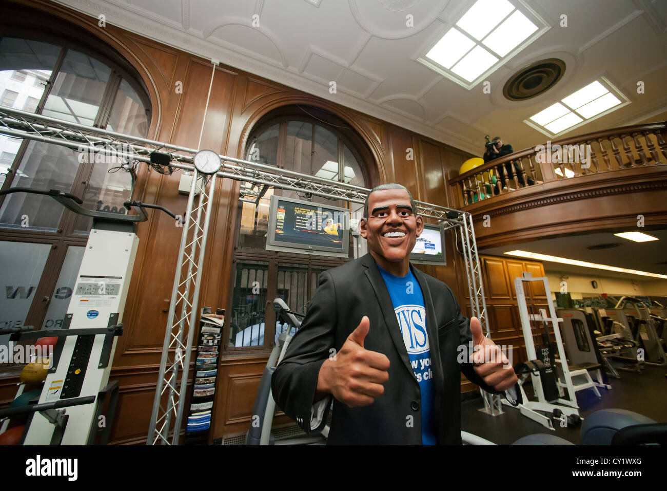 Exercisers dressed in suits and Barack Obama and Mitt Romney masks run ...