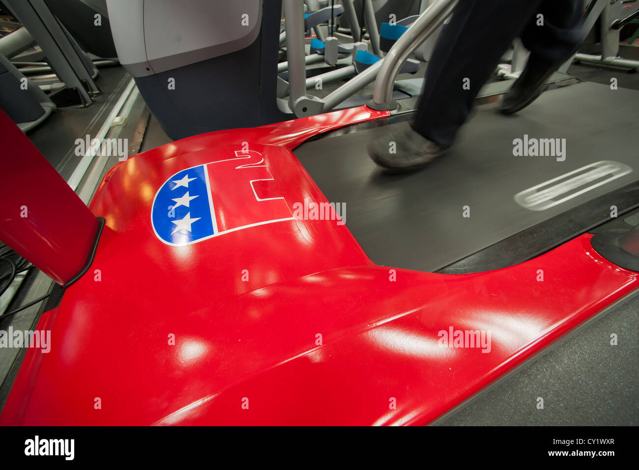 Exercisers dressed in suits and Barack Obama and Mitt Romney masks run ...