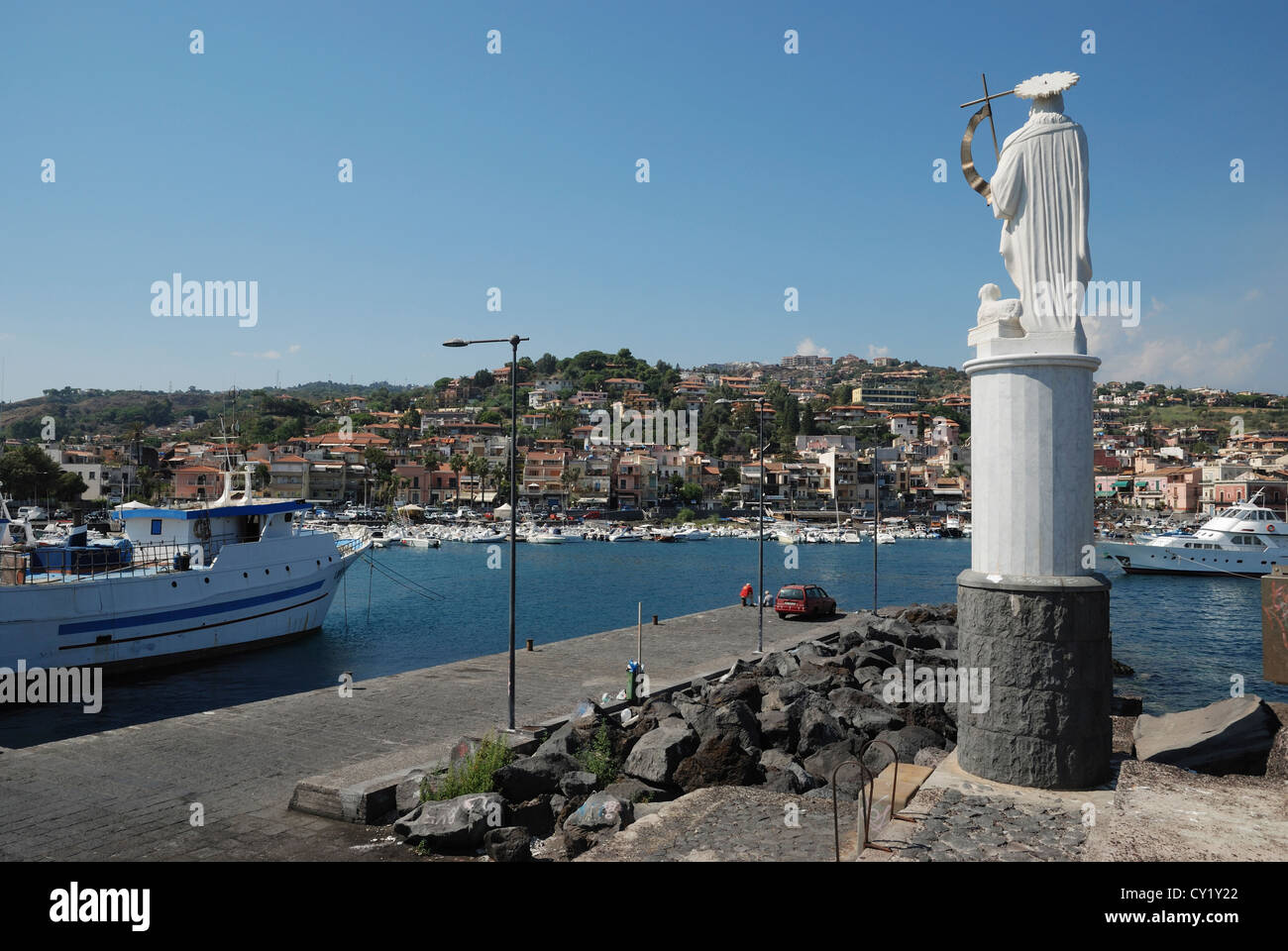 A statue overlooking the harbour at Aci Trezza, Sicily, Italy Stock ...
