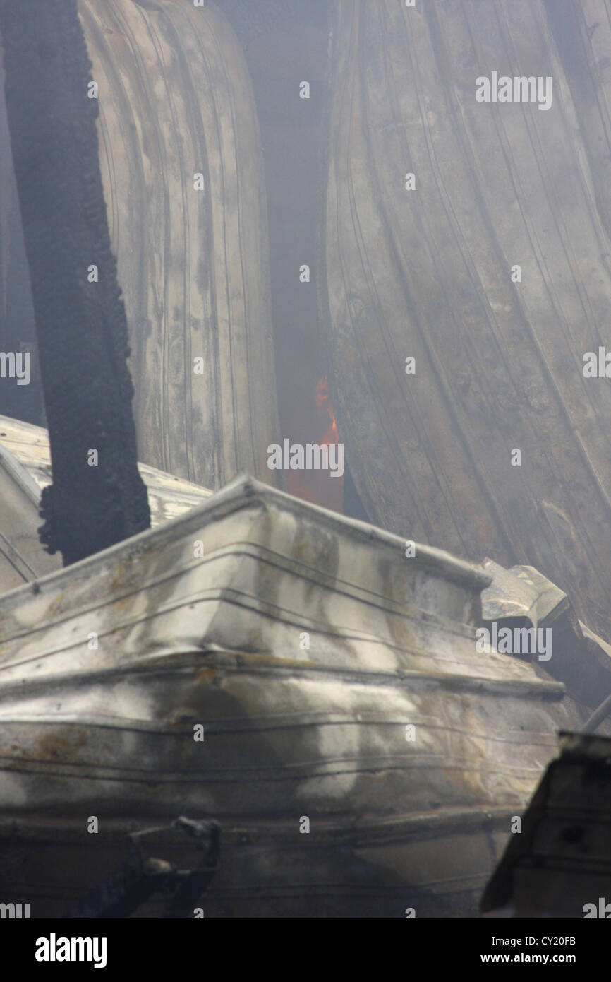 Debris burning in a collapsed building Stock Photo - Alamy