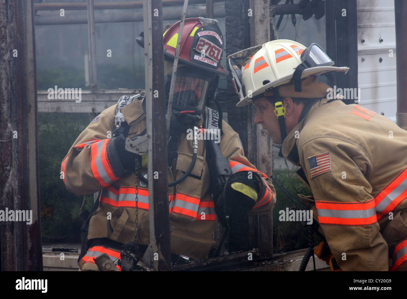 Two firefighters communicating at the scene of a fire Stock Photo - Alamy