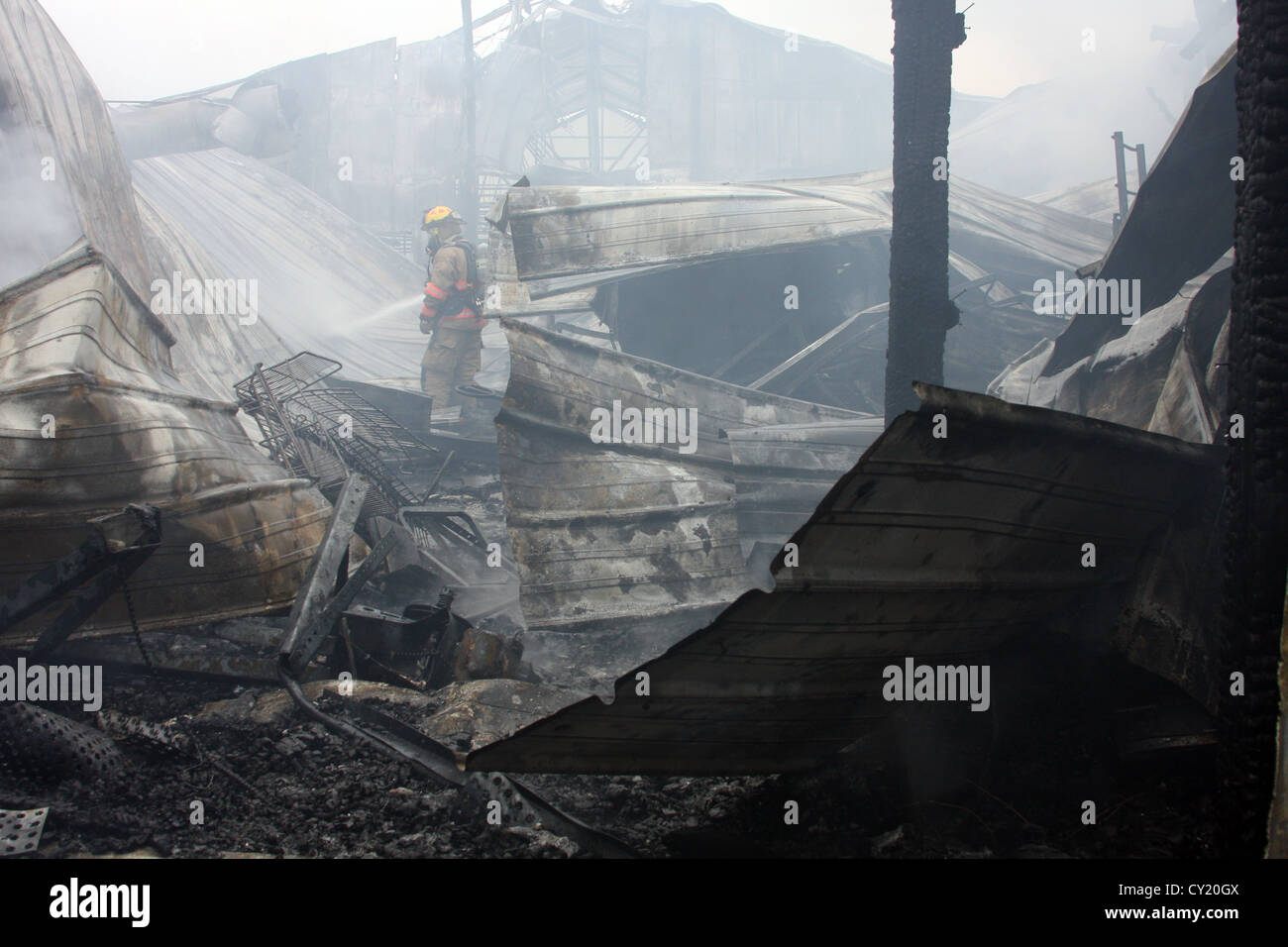 A firefighter in the middle of the debris from a collapsed building in ...