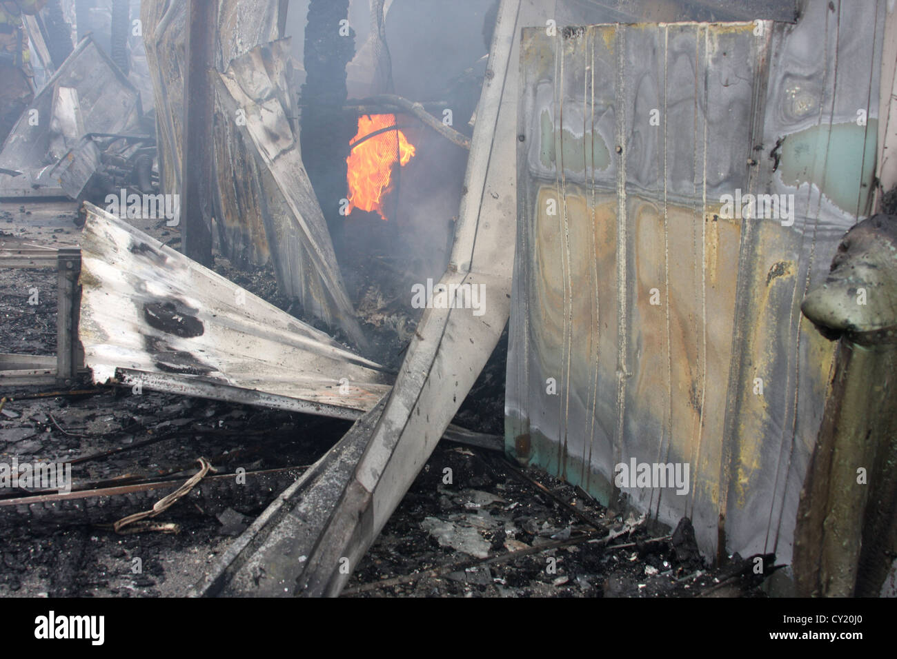 Flames in a burning building that has collapsed Stock Photo - Alamy