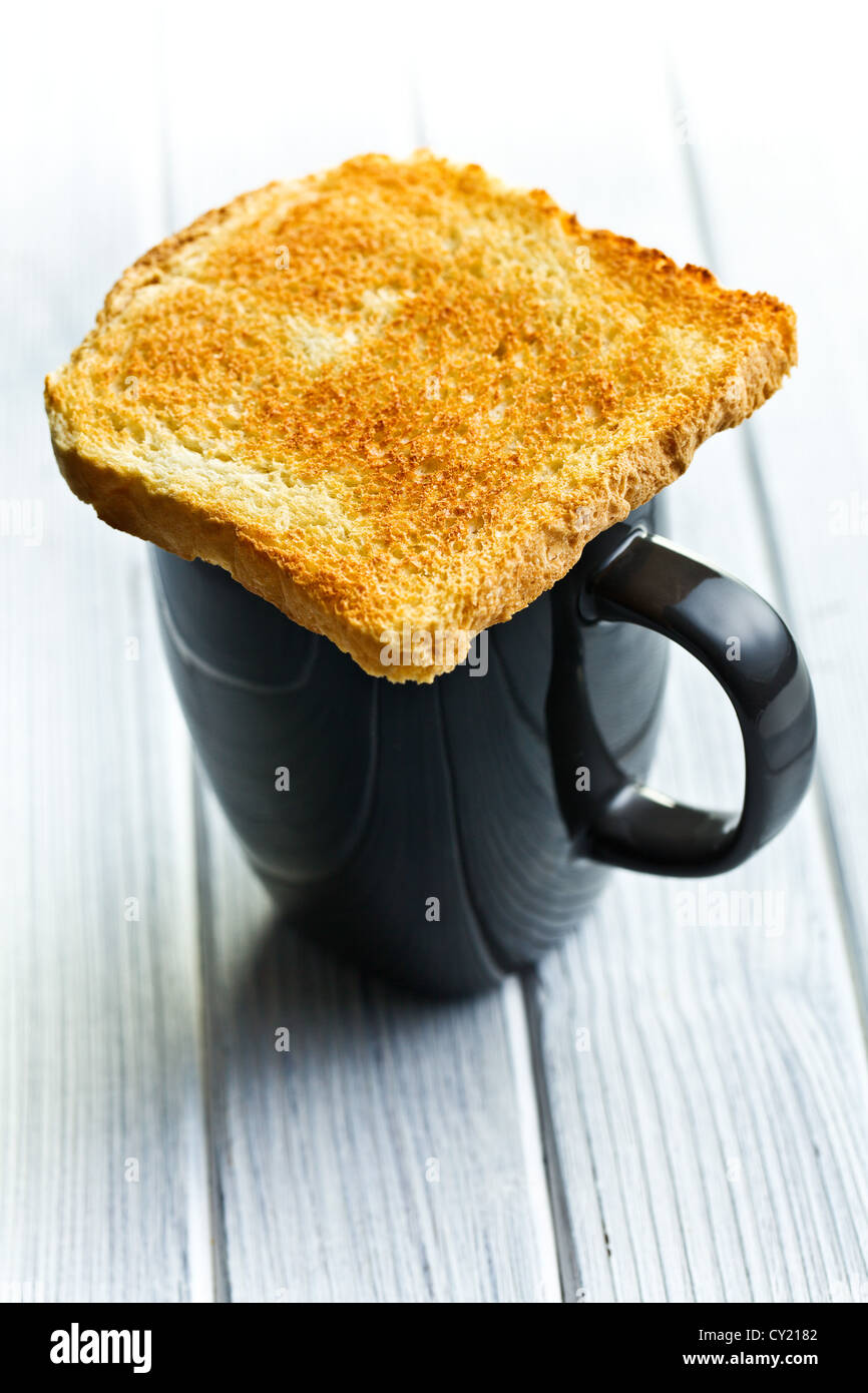 Breakfast. Toasted bread placed on the coffee mug Stock Photo - Alamy