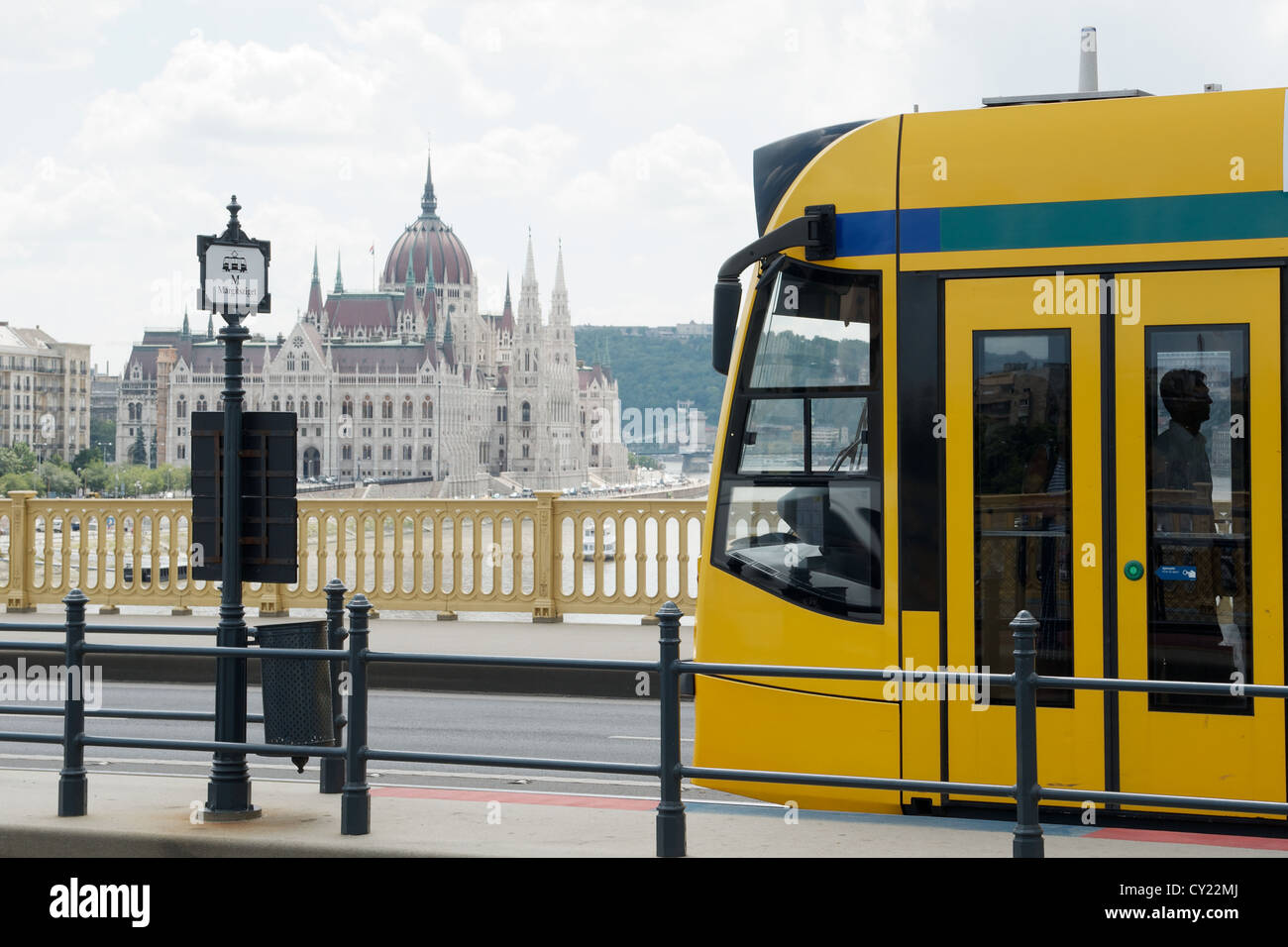 Modern yellow tram in Budapest Hungary. Hungarian Parliament building ...