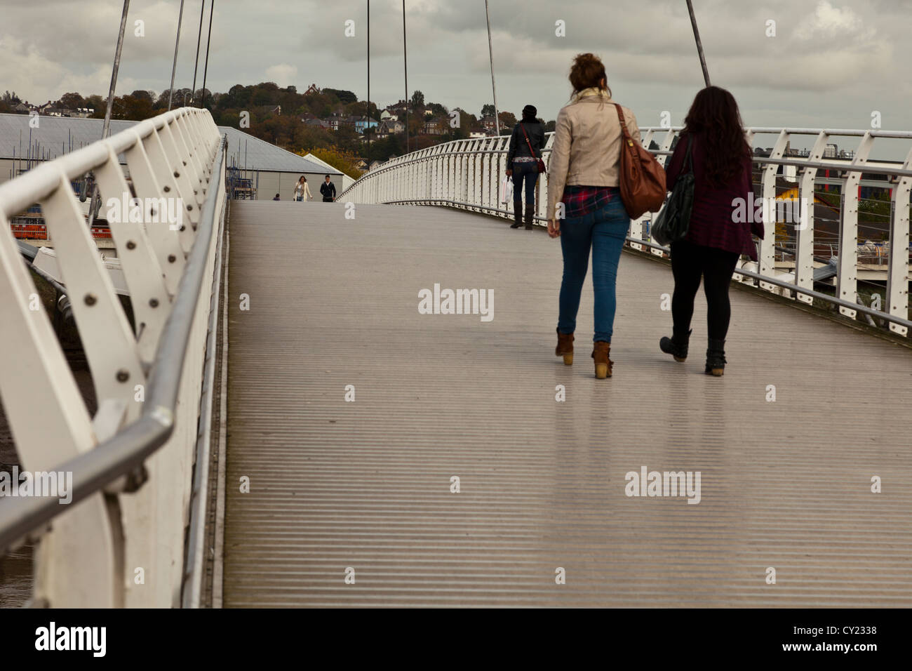 Pedestrians people walking over millennium footbridge spanning across ...