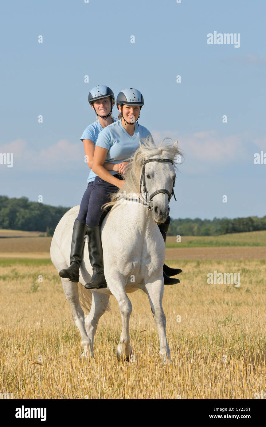 Two girls on ponies riding hi-res stock photography and images - Alamy