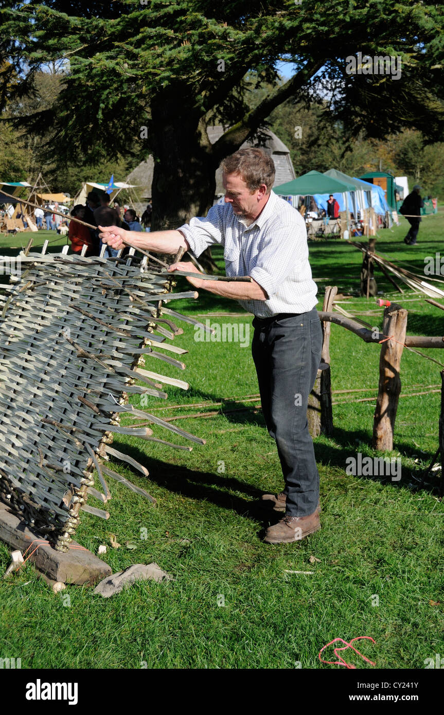 Hurdle maker threading split ash into a hurdle for sheep pens and ...