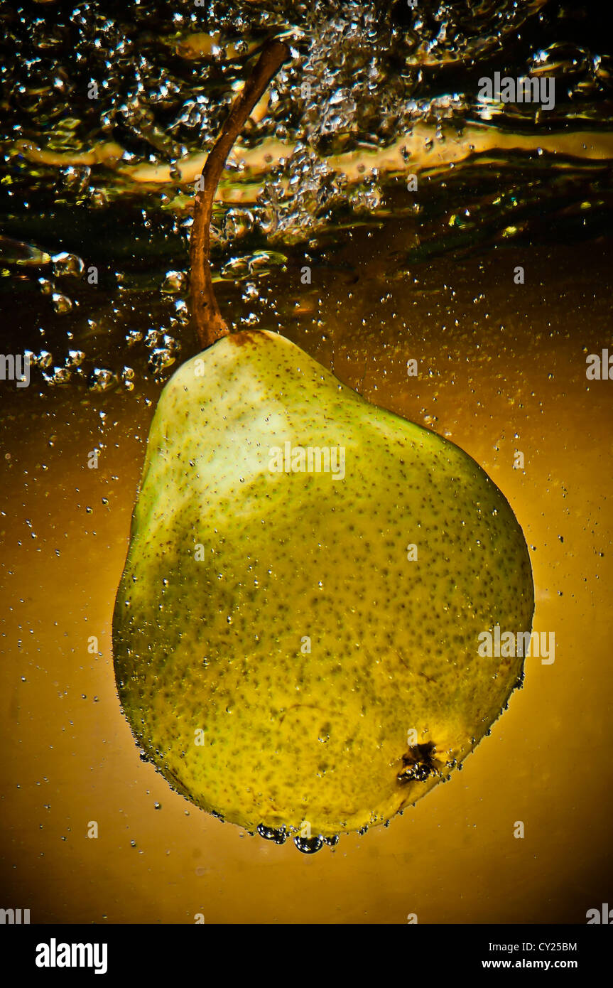Creative image of a Pear in water against a Gold background Stock Photo ...