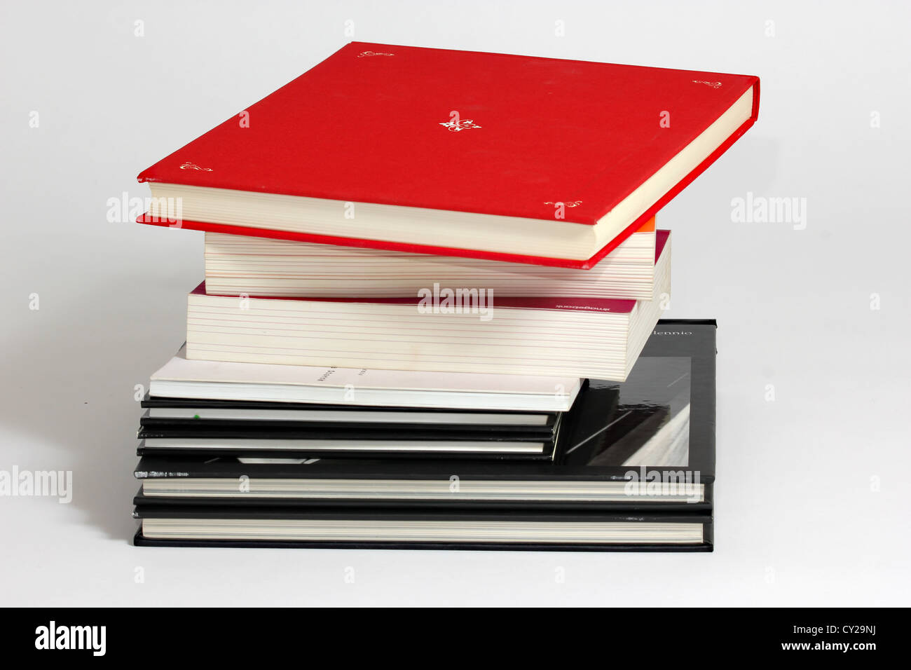 books piled up, against a clear white background, studio shot ...