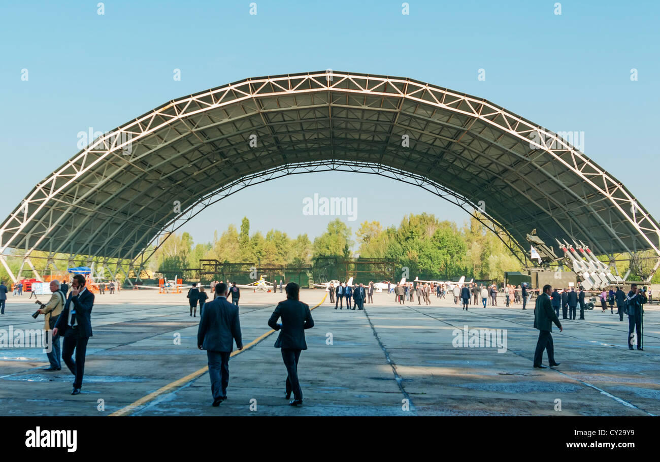 Exhibition of aviation equipment under an open hangar. Exhibition ...