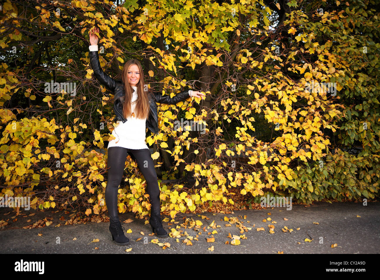 Young woman stand autumn leaves fall yellow green girl garden ...