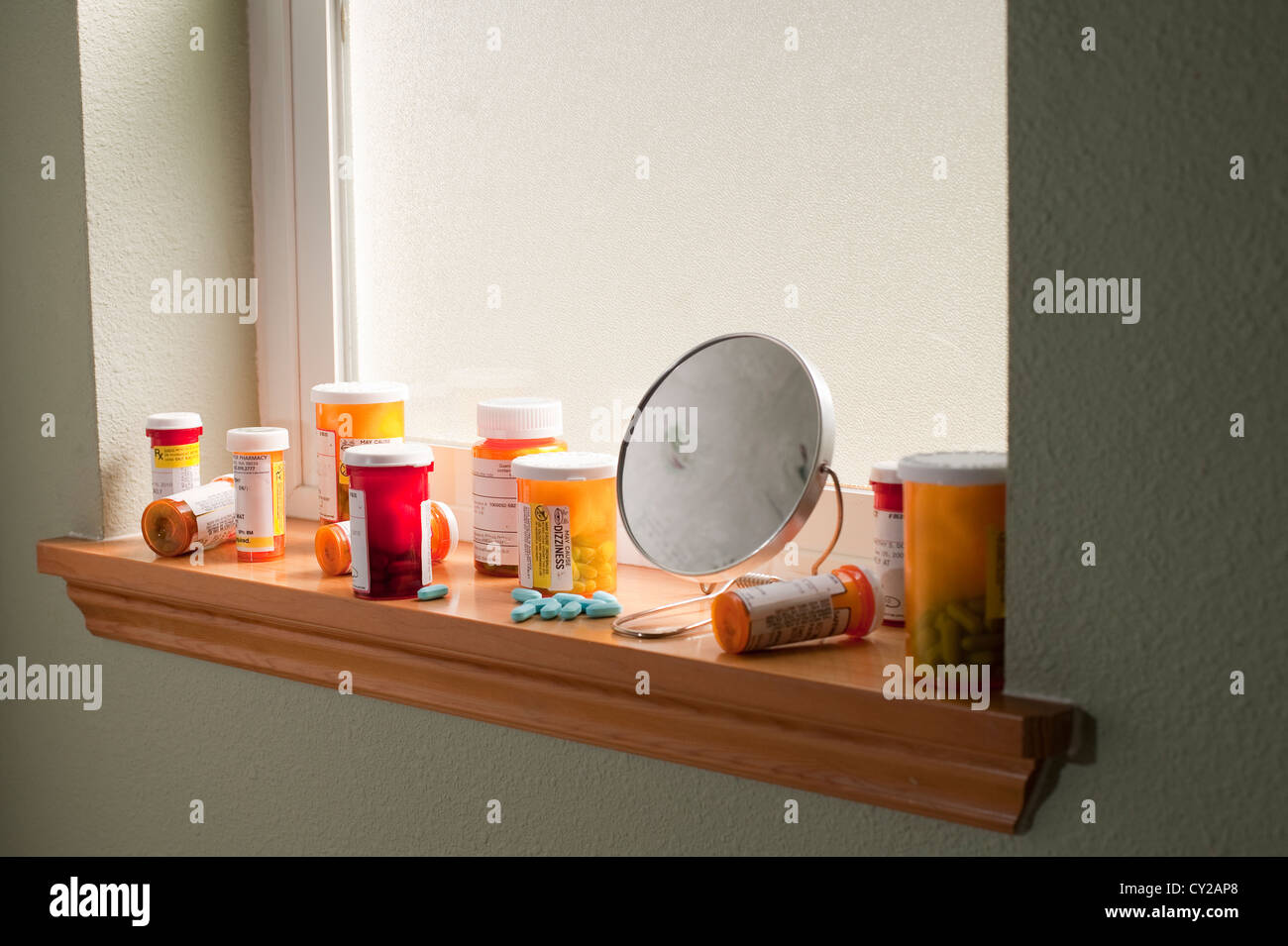 Pills and pill bottles along window sill with mirror Stock Photo - Alamy
