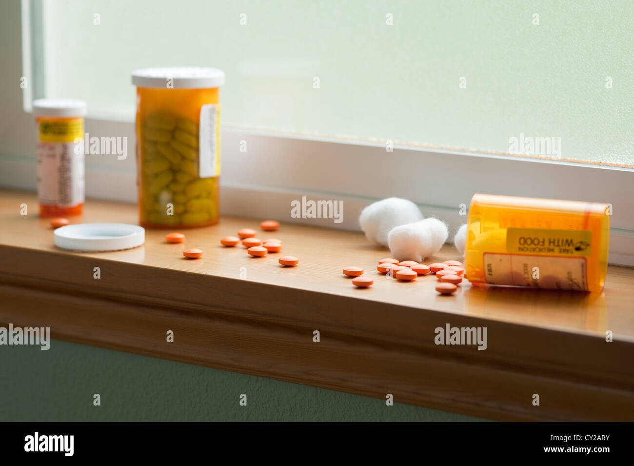 Pills and pill bottles along window sill Stock Photo - Alamy