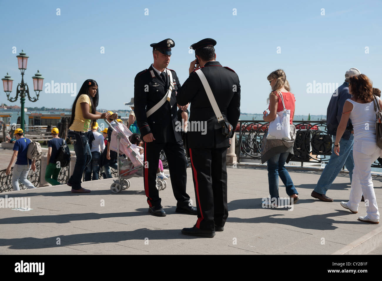 Italian police, two Carabinieri stand talking in Venice as tourists ...