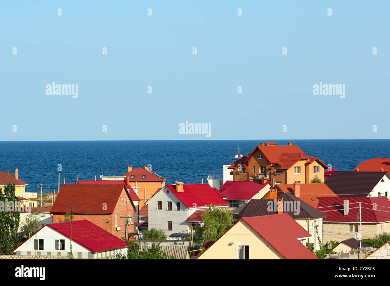 Colored roofs at the seaside with clear blue sky Stock Photo - Alamy