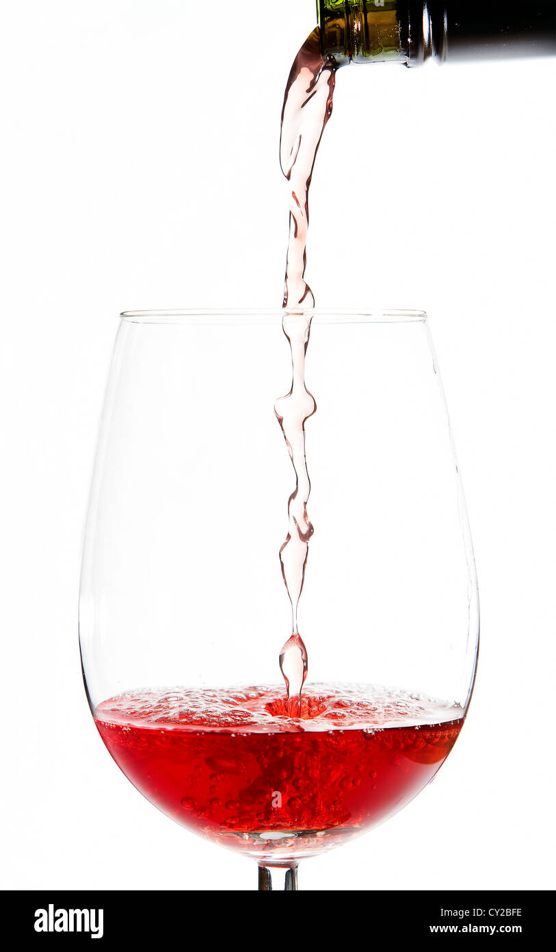 Pale red wine pouring slowly into glass Stock Photo - Alamy