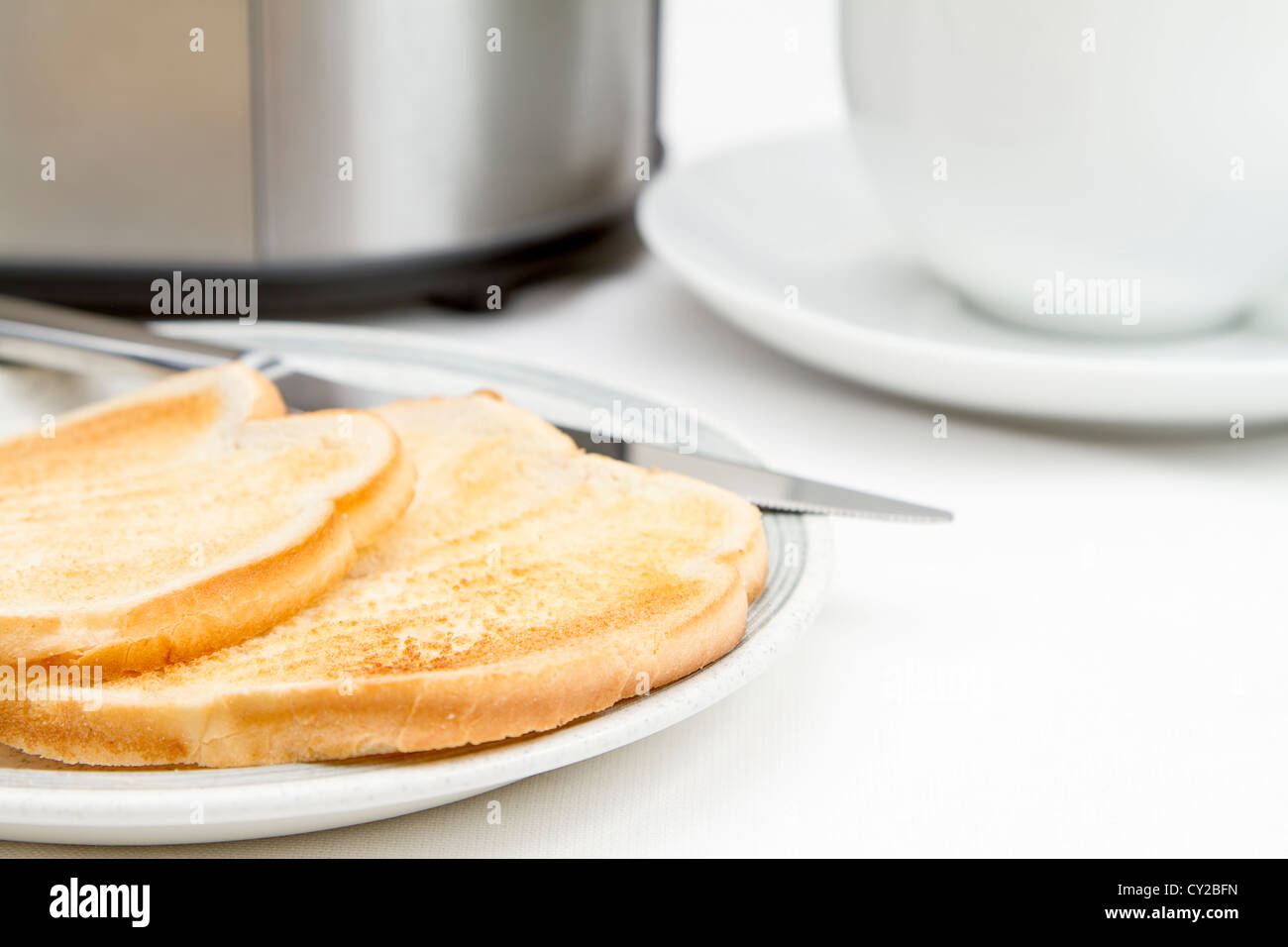 Two slices of toast with toaster and cup Stock Photo - Alamy