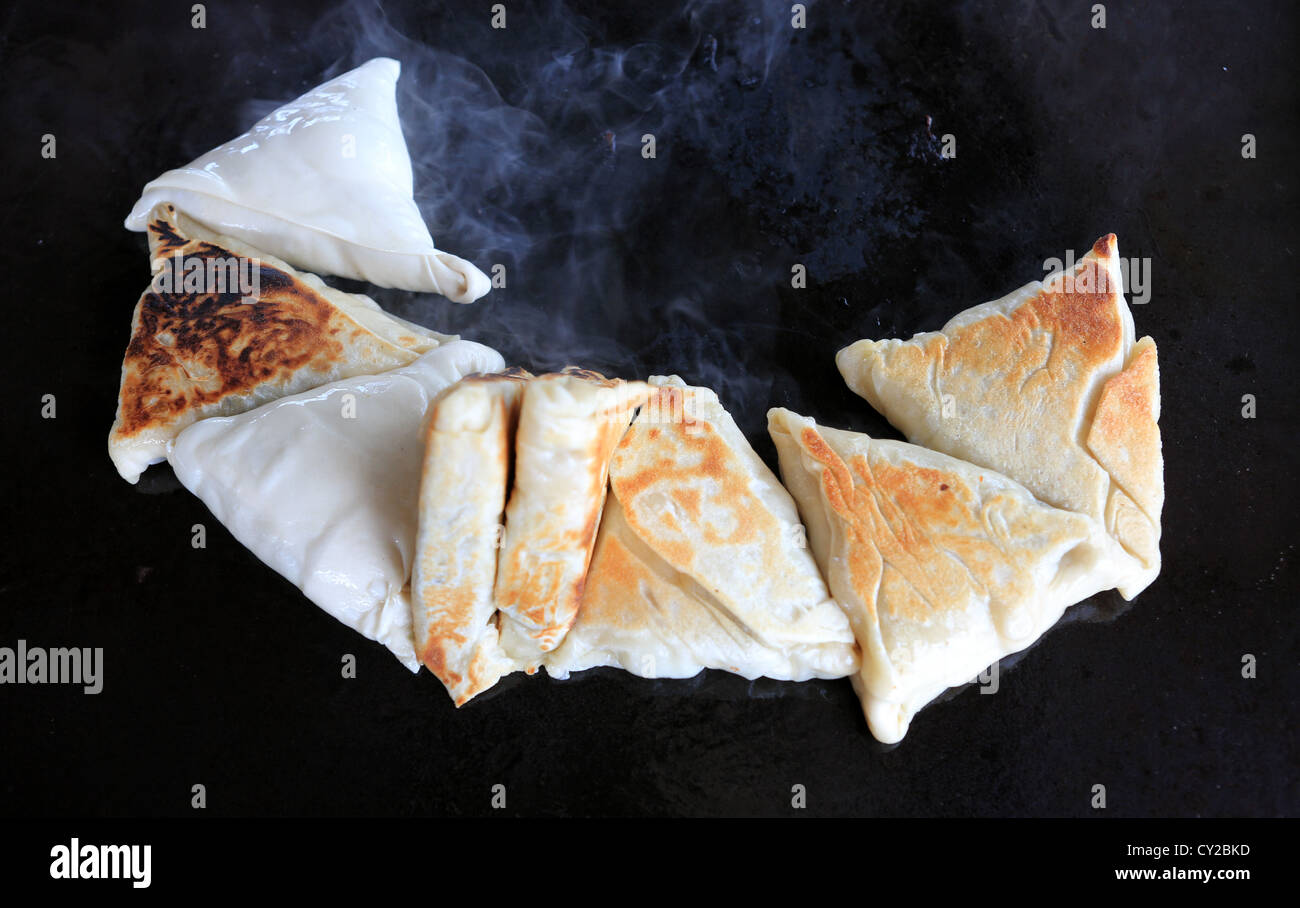 Triangle shaped vegetable rote on the grill Stock Photo - Alamy