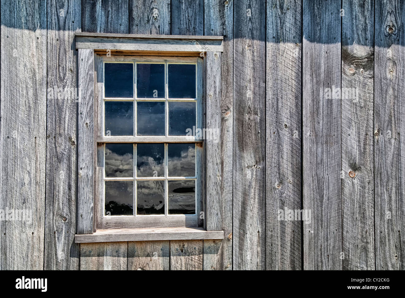Window of an authentic wooden pioneer house. An example of an early ...