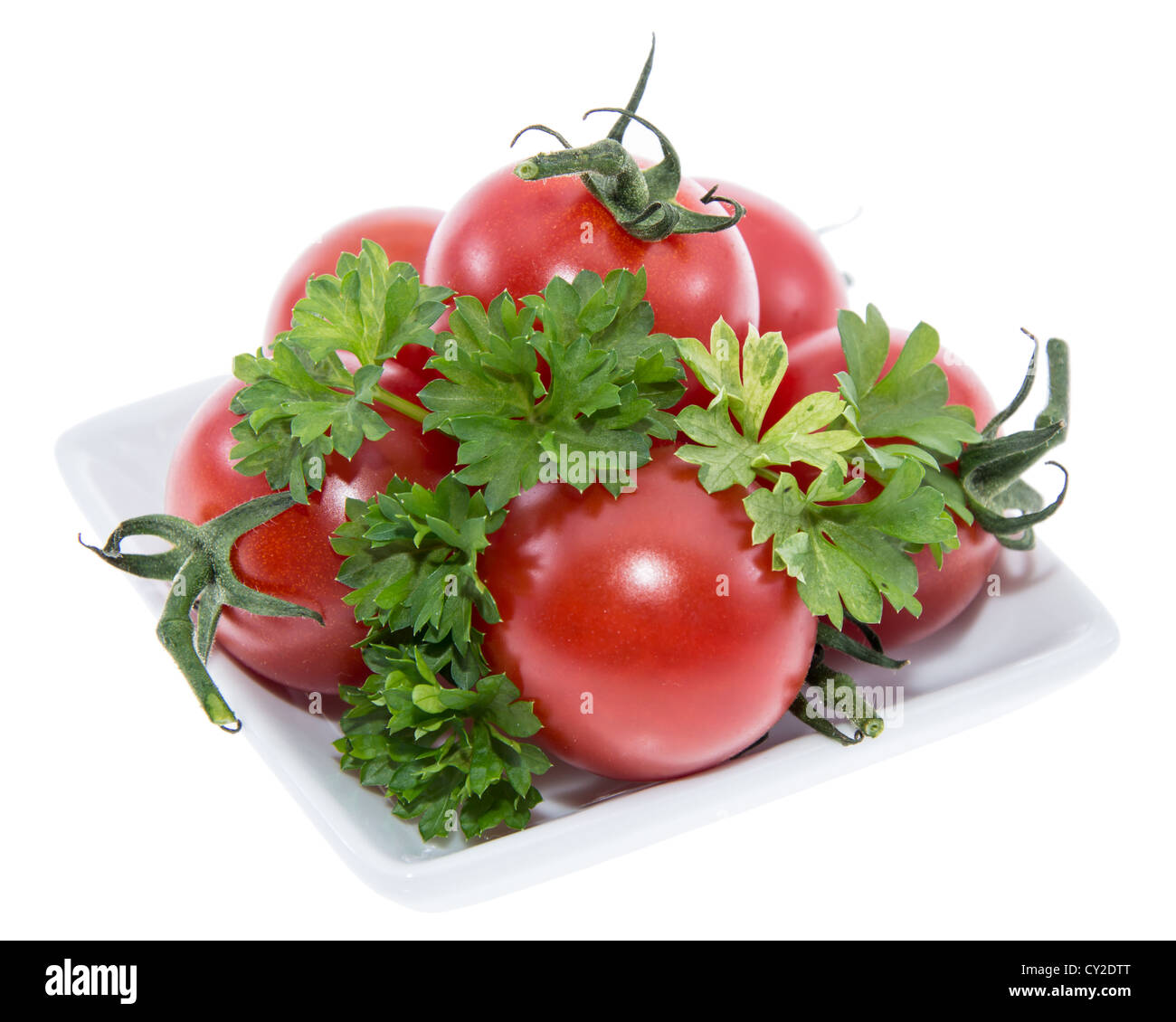 Heap of Tomatoes on a plate isolated on white Stock Photo - Alamy