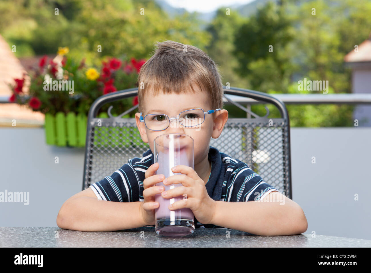 Little boy sipping milk drink Stock Photo - Alamy