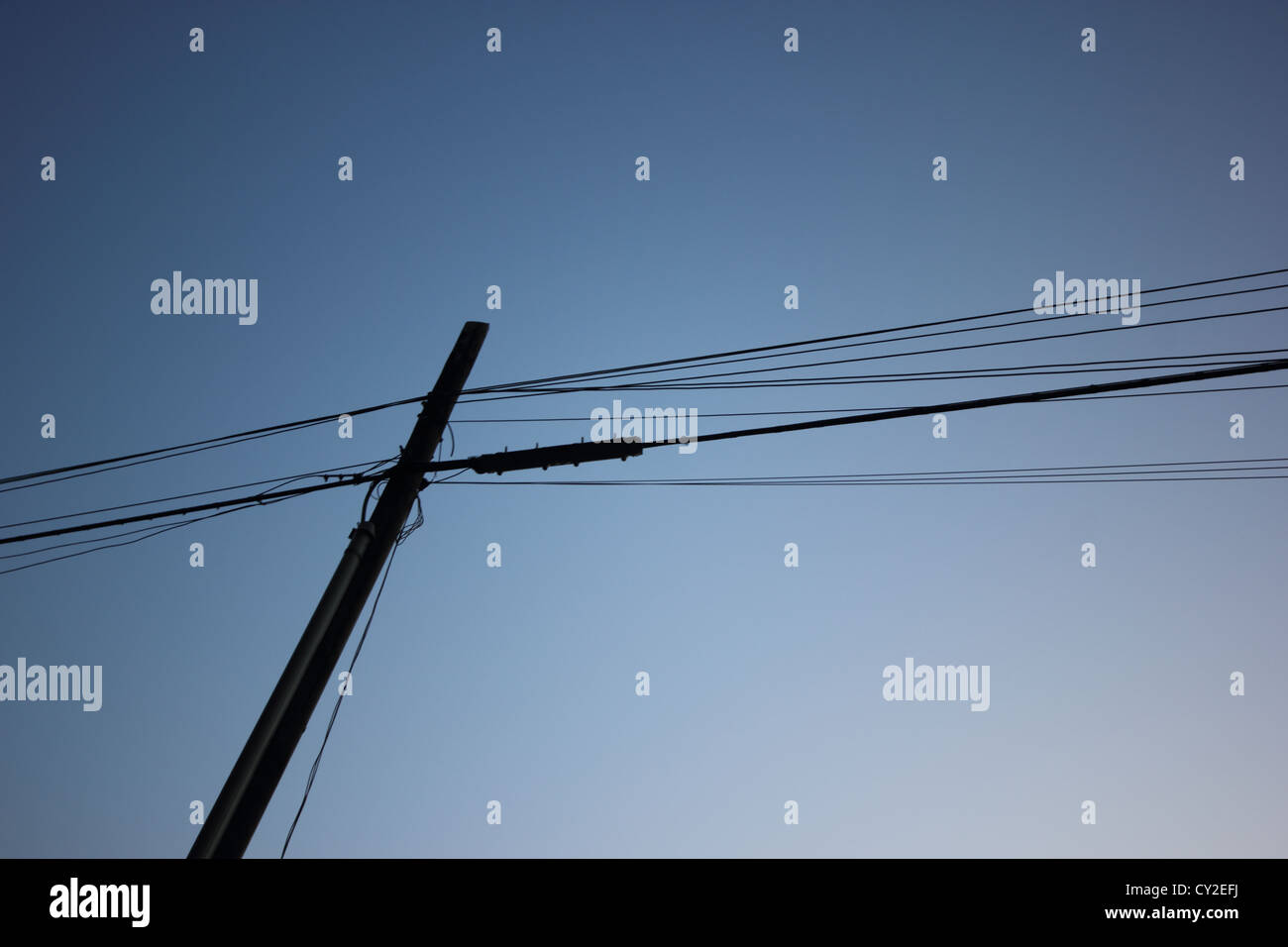telephone pole with wires against a clear blue sky, electricity ...