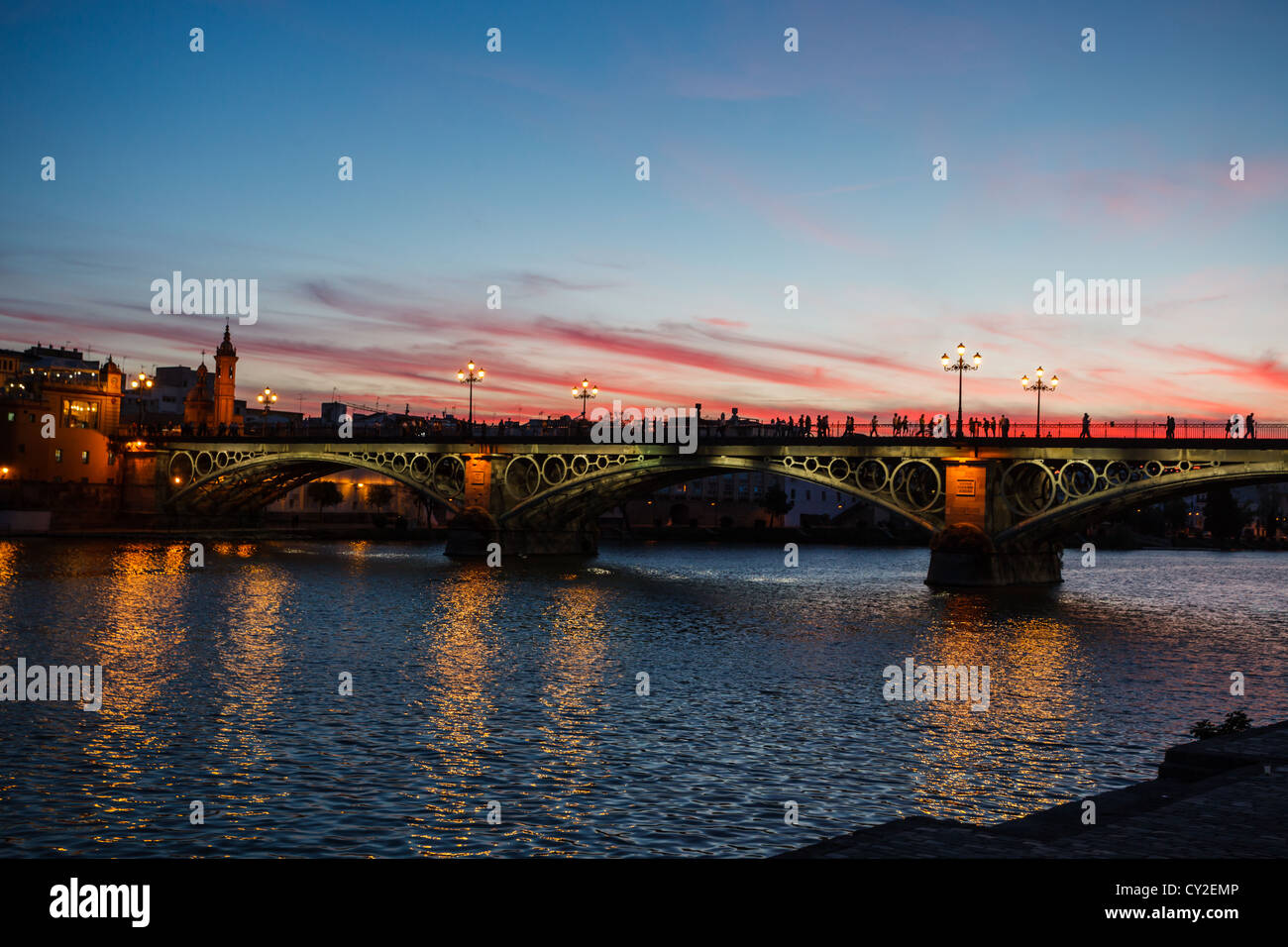 Twilight view of Isabel II Bridge in Seville, Spain with bridge lights ...