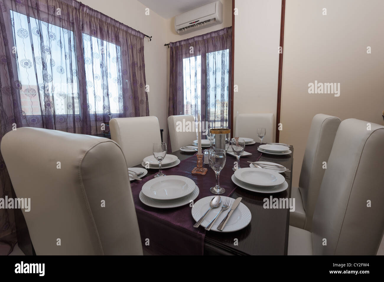 Dining room with table and settings in a luxury apartment Stock Photo ...